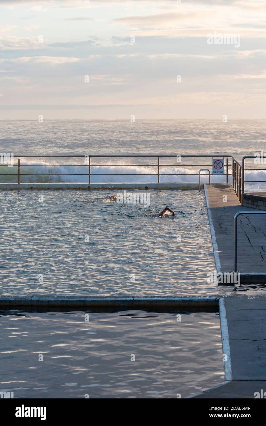 With Ocean waves rolling in early morning swimmers doing laps at Black ...