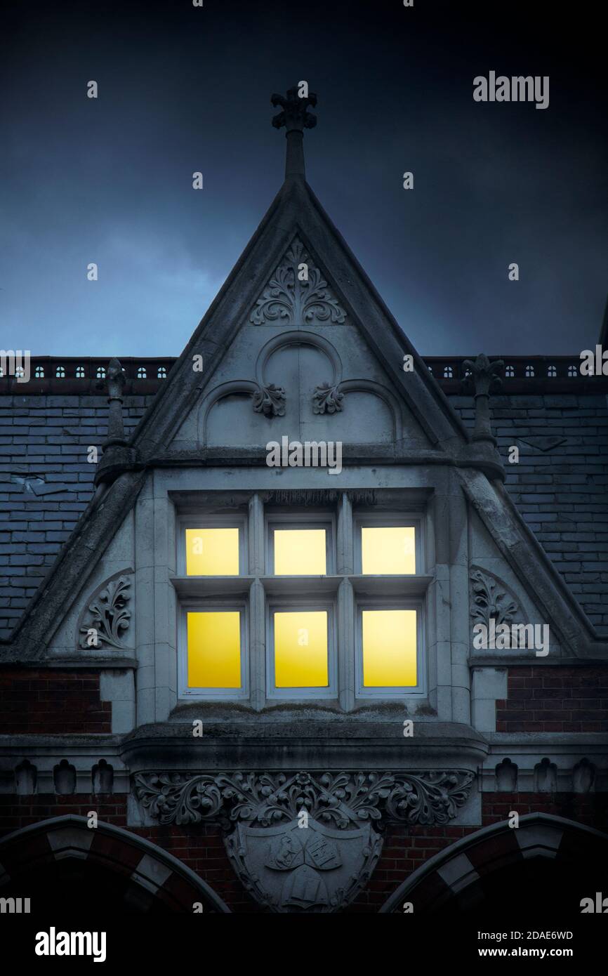 Gothic Attic Window Lit Up Stock Photo - Alamy