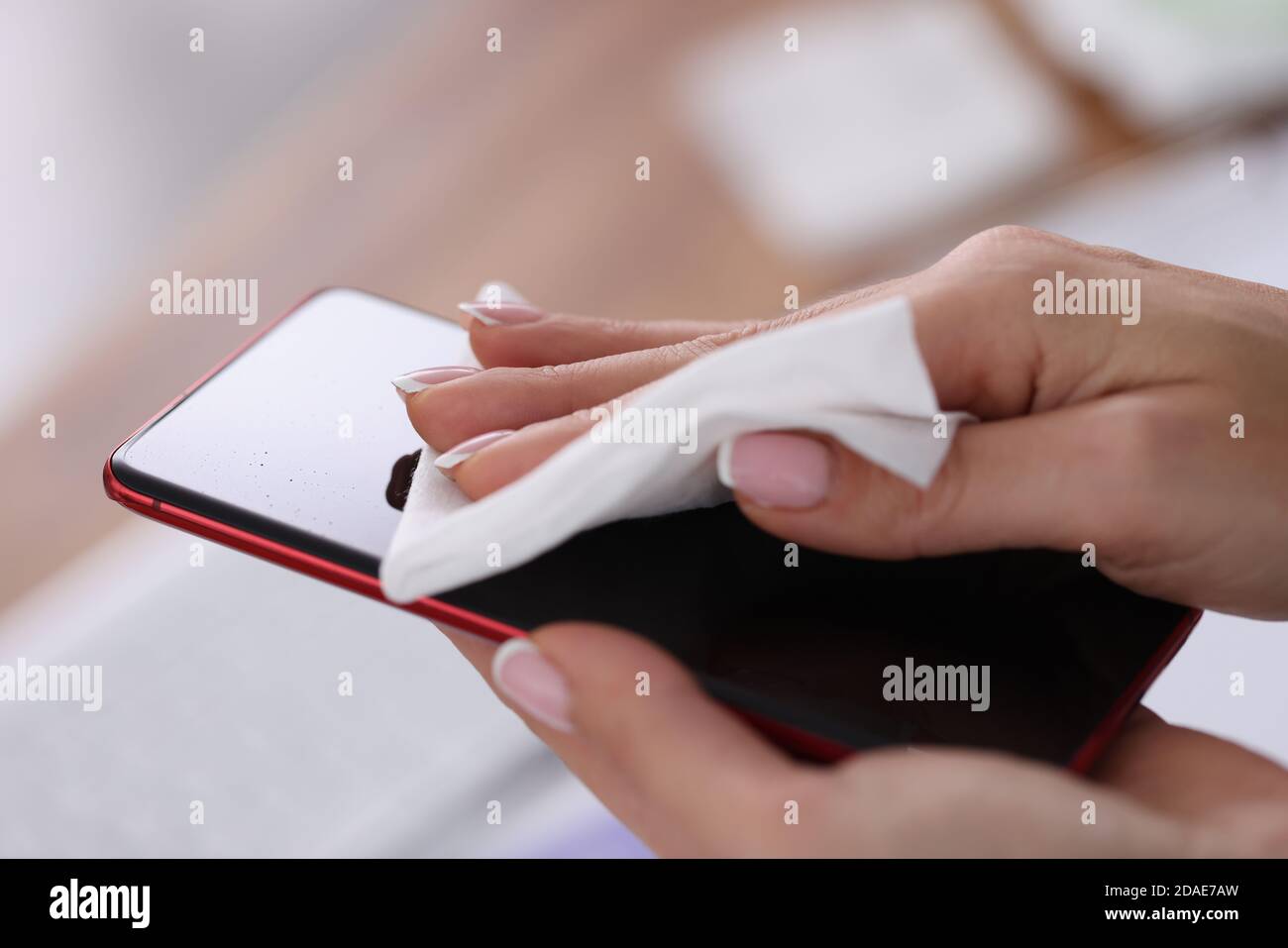Woman wiping mobile phone with antistatic cloth at home closeup Stock ...