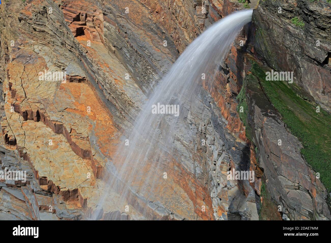 View of the waterfall cascading on to the beach at Sandymouth Cornwall ...