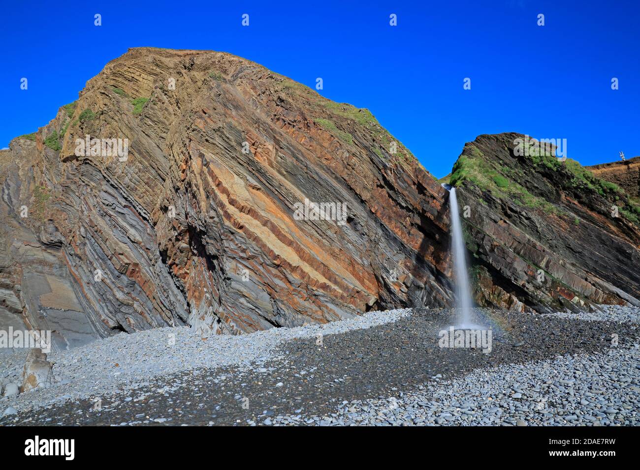 View of the waterfall cascading on to the beach at Sandymouth Cornwall ...