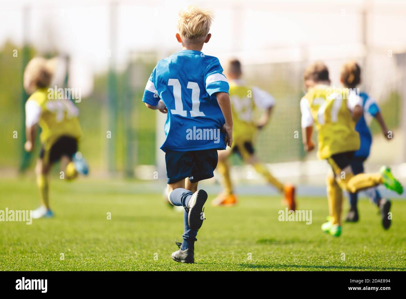 School boys playing football hi-res stock photography and images - Alamy