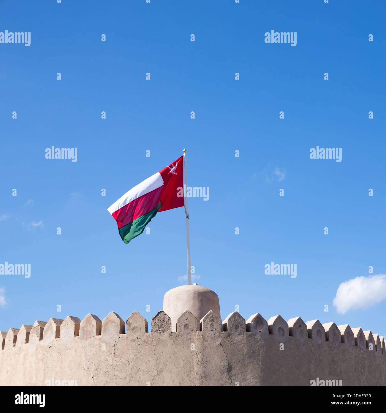 Flag on roof of fort in Oman. Blue sky copy space Stock Photo - Alamy