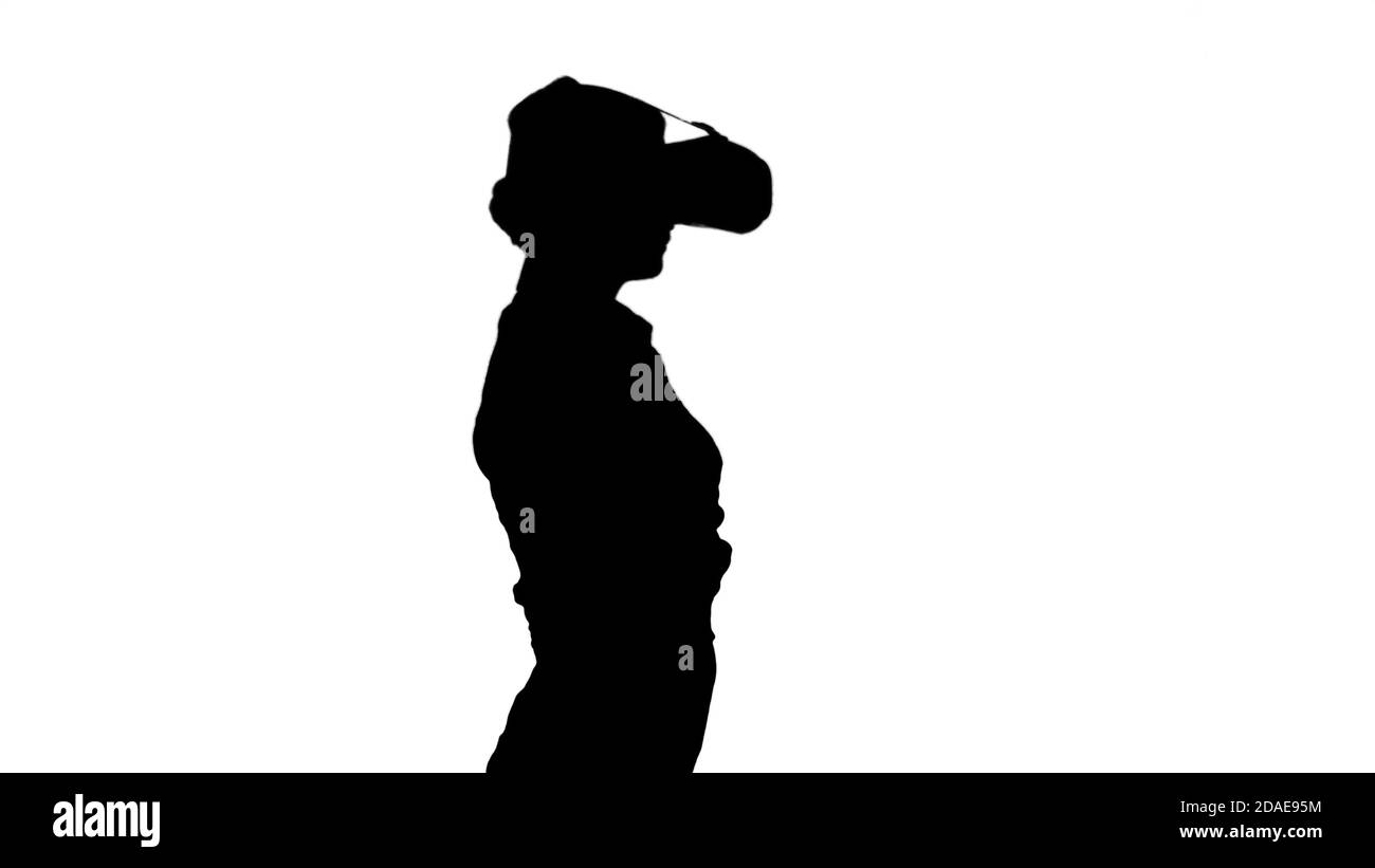 Silhouette Woman in VR headset walking Stock Photo - Alamy