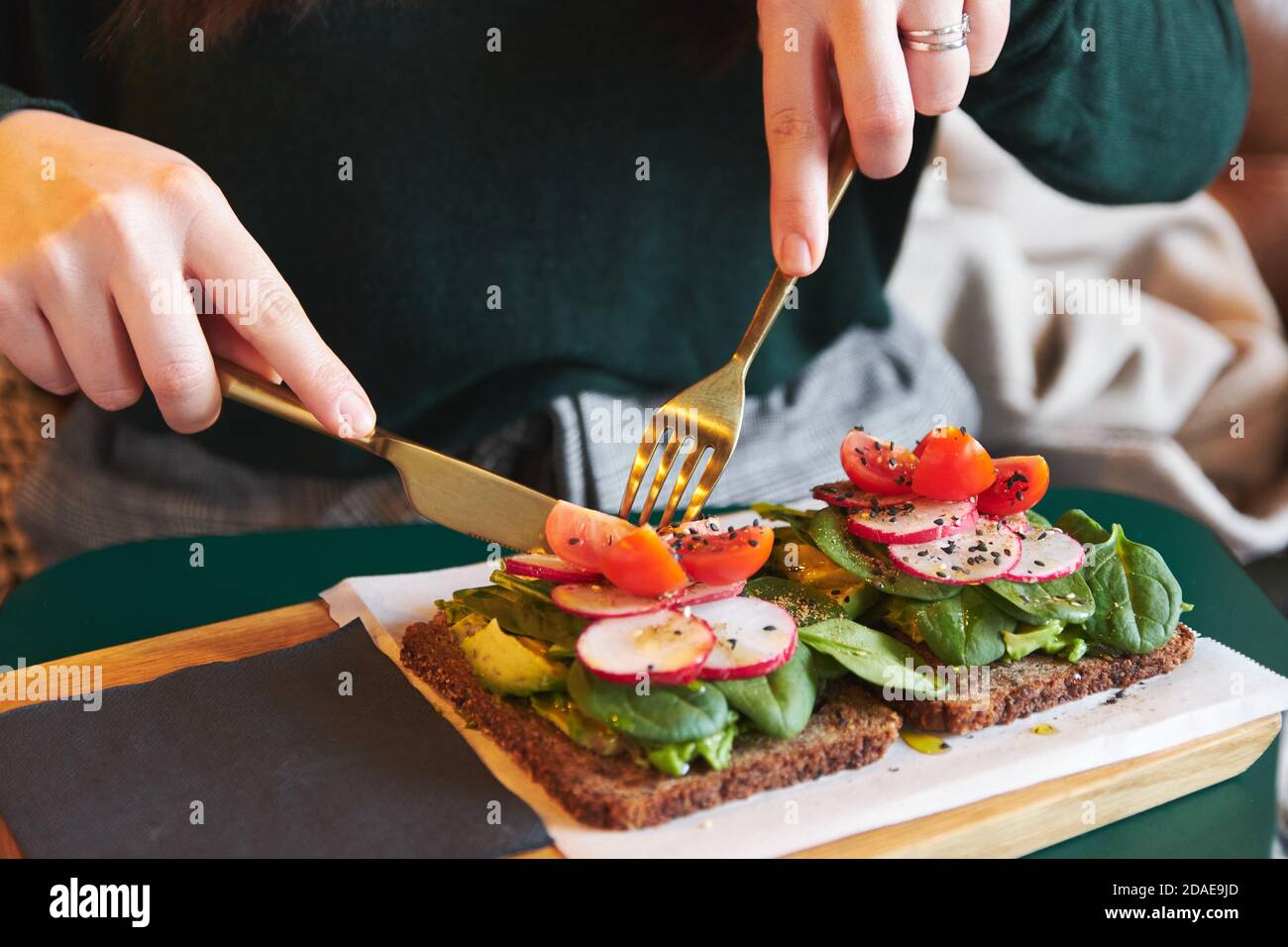 Closeup shot of female hands eating vegetable sandwiches Stock Photo ...
