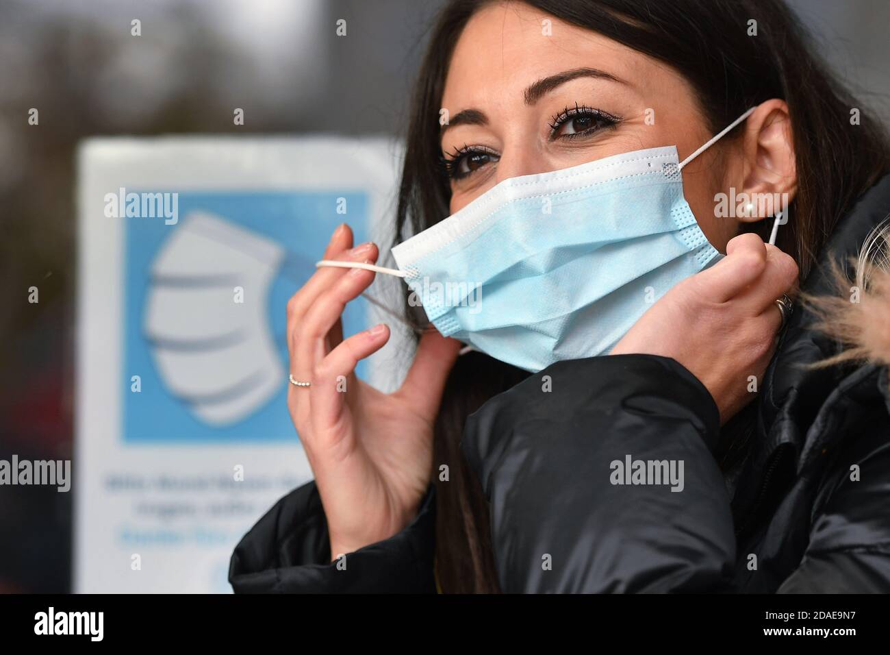 Young woman with face mask, mask. Sign Mask compulsory Mask compulsory ...
