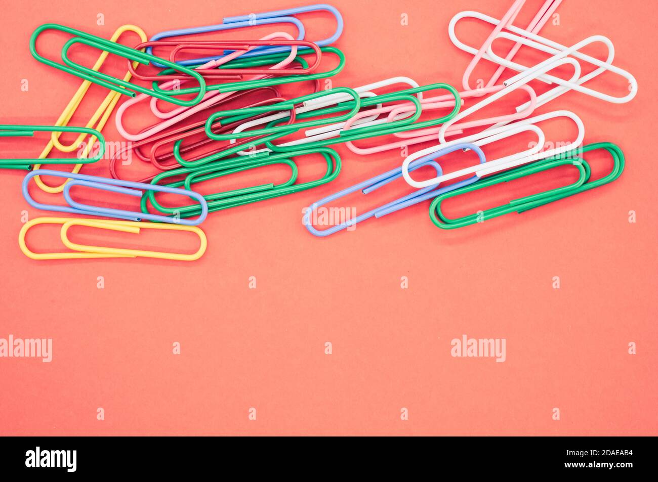 Closeup shot of multicolored paper clips on a piece of paper Stock ...