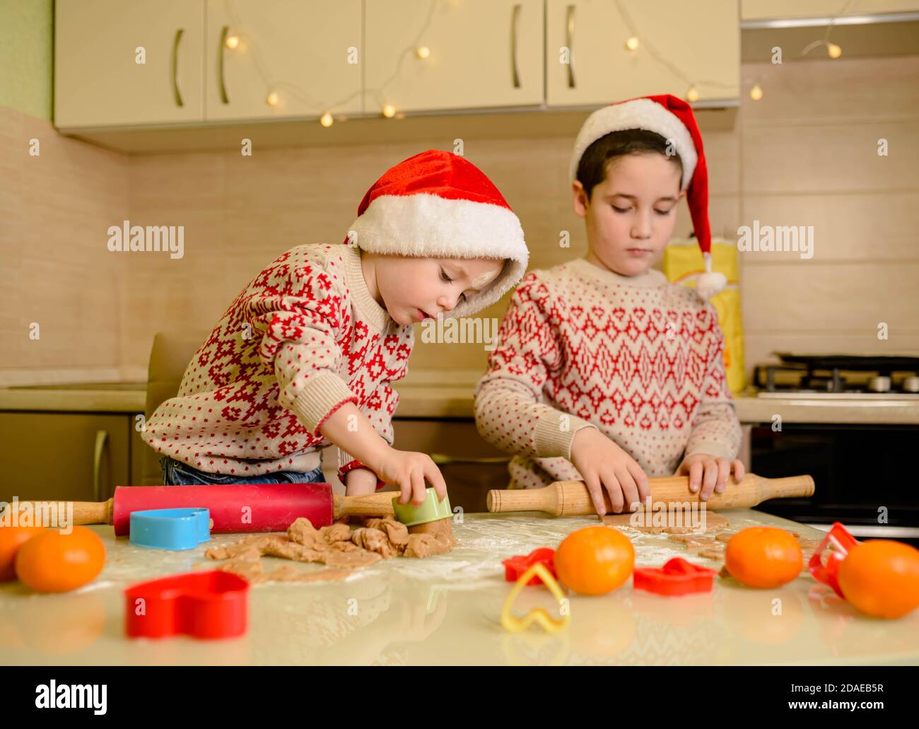 Funny children prepare holiday food for family. Santa chefs. Xmas Stock ...