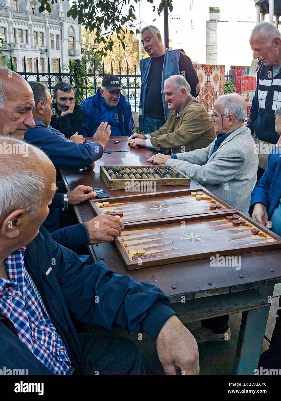 Georgian men playing a board game together at a table hi-res stock ...