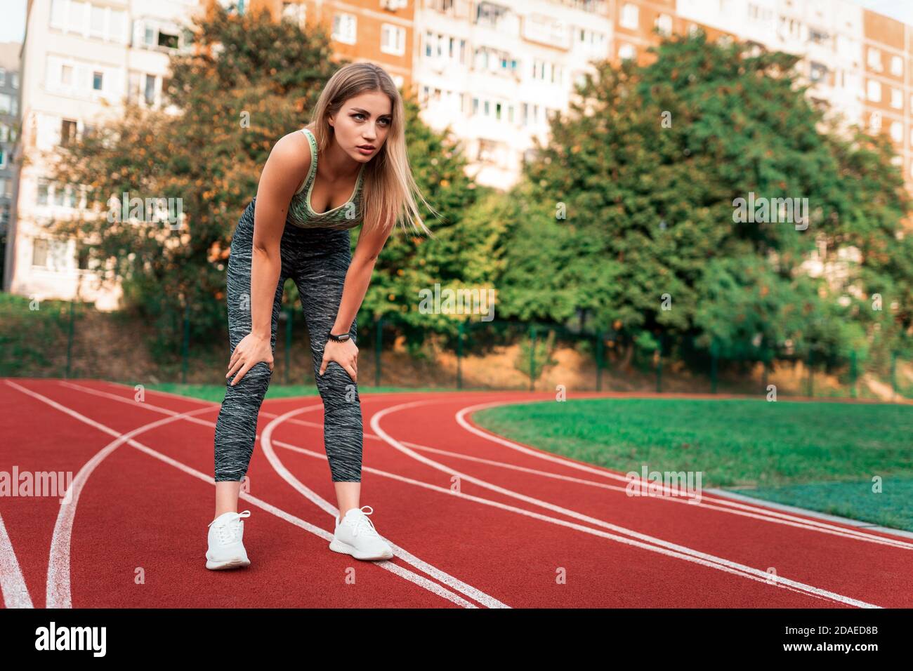 Athletic girl resting after running Stock Photo - Alamy