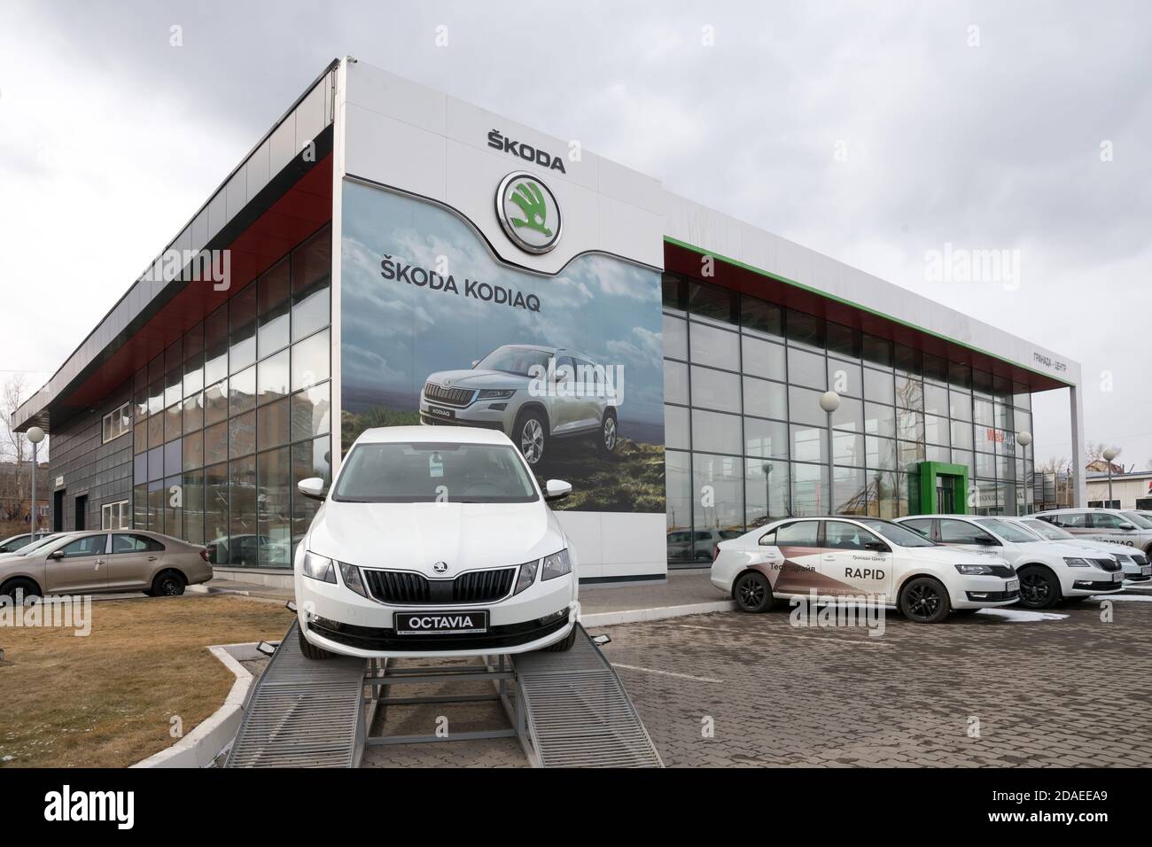 Test drive cars are standing in front of a car dealership building on ...