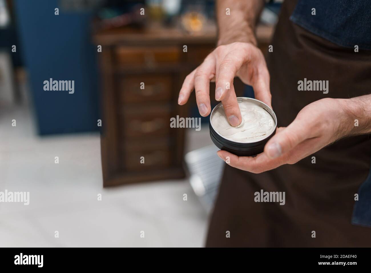 Hairdresser using pomade to hair styling Stock Photo - Alamy