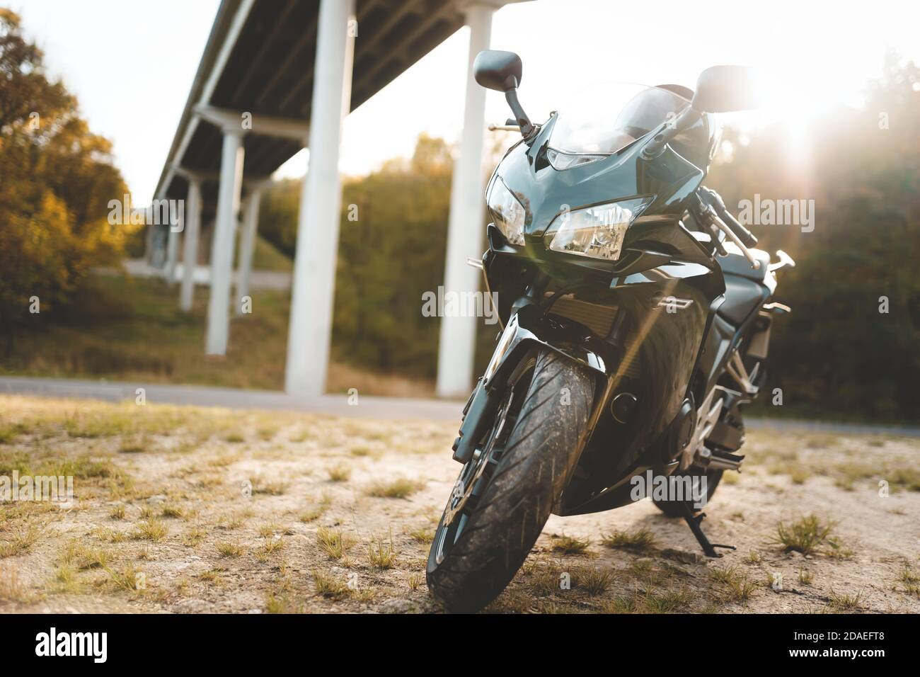 Fast black sports bike parked near bridge Stock Photo - Alamy