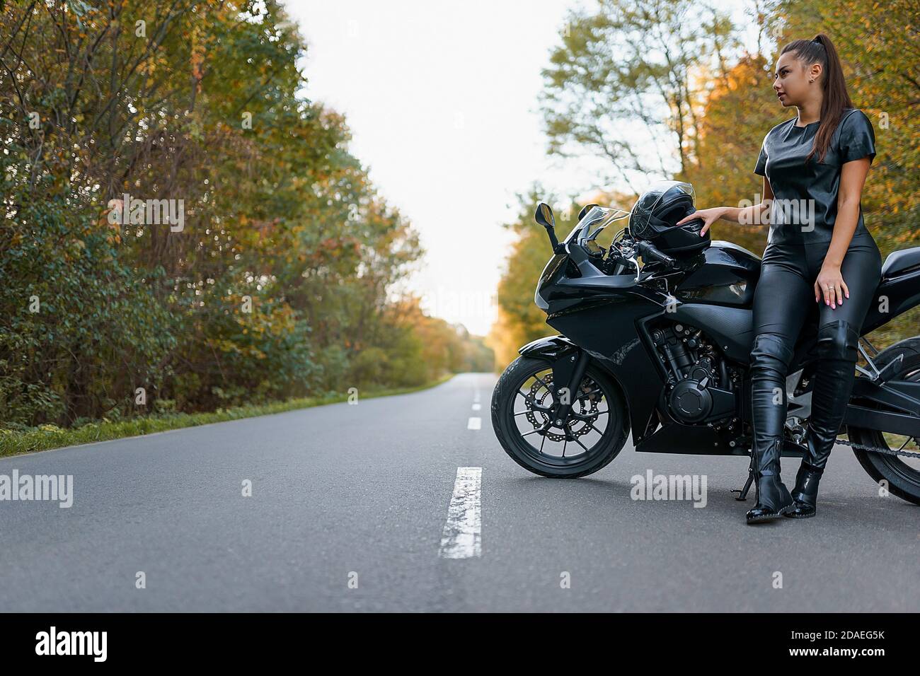 Stylish female motorcyclist on the road Stock Photo - Alamy