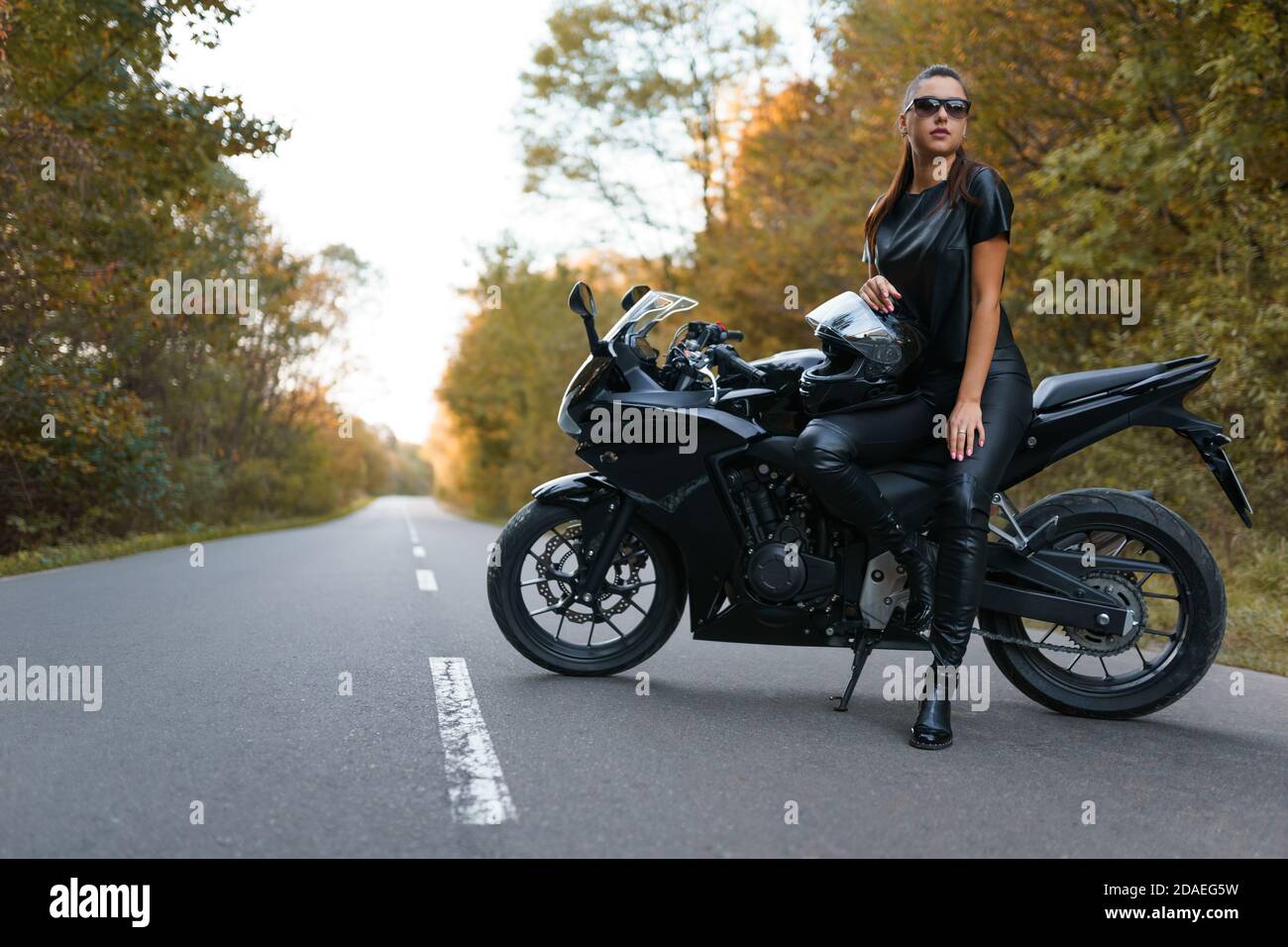 Stylish female motorcyclist on the road Stock Photo - Alamy