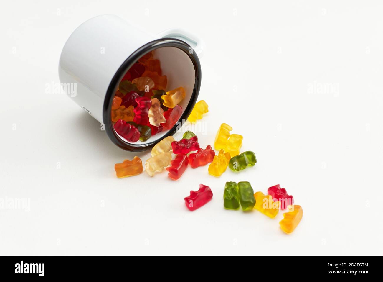 Closeup shot of colorful gummy bears falling out of a cup Stock Photo ...
