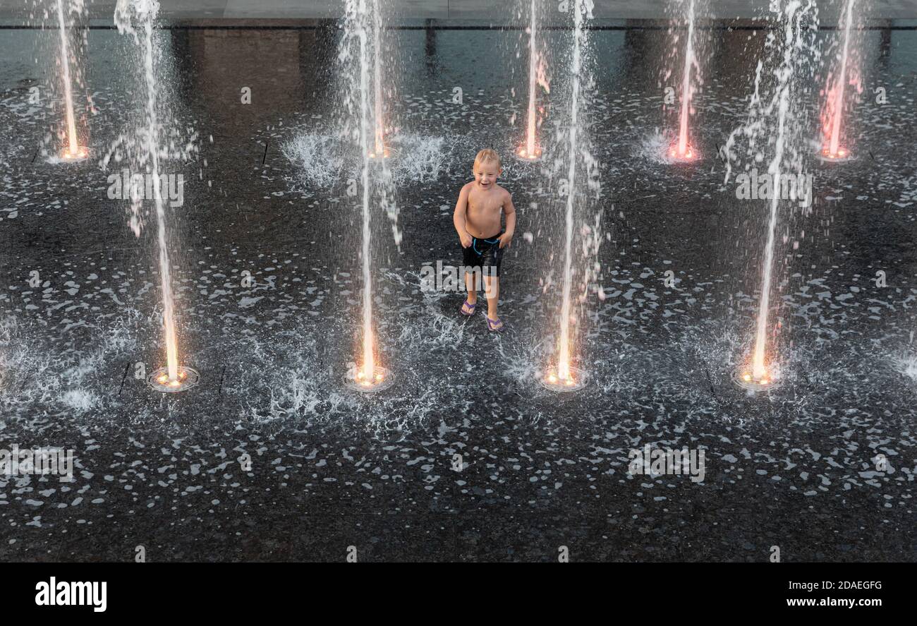 KYIV, UKRAINE - Jul. 28, 2020: Children playing in a water fountain and ...