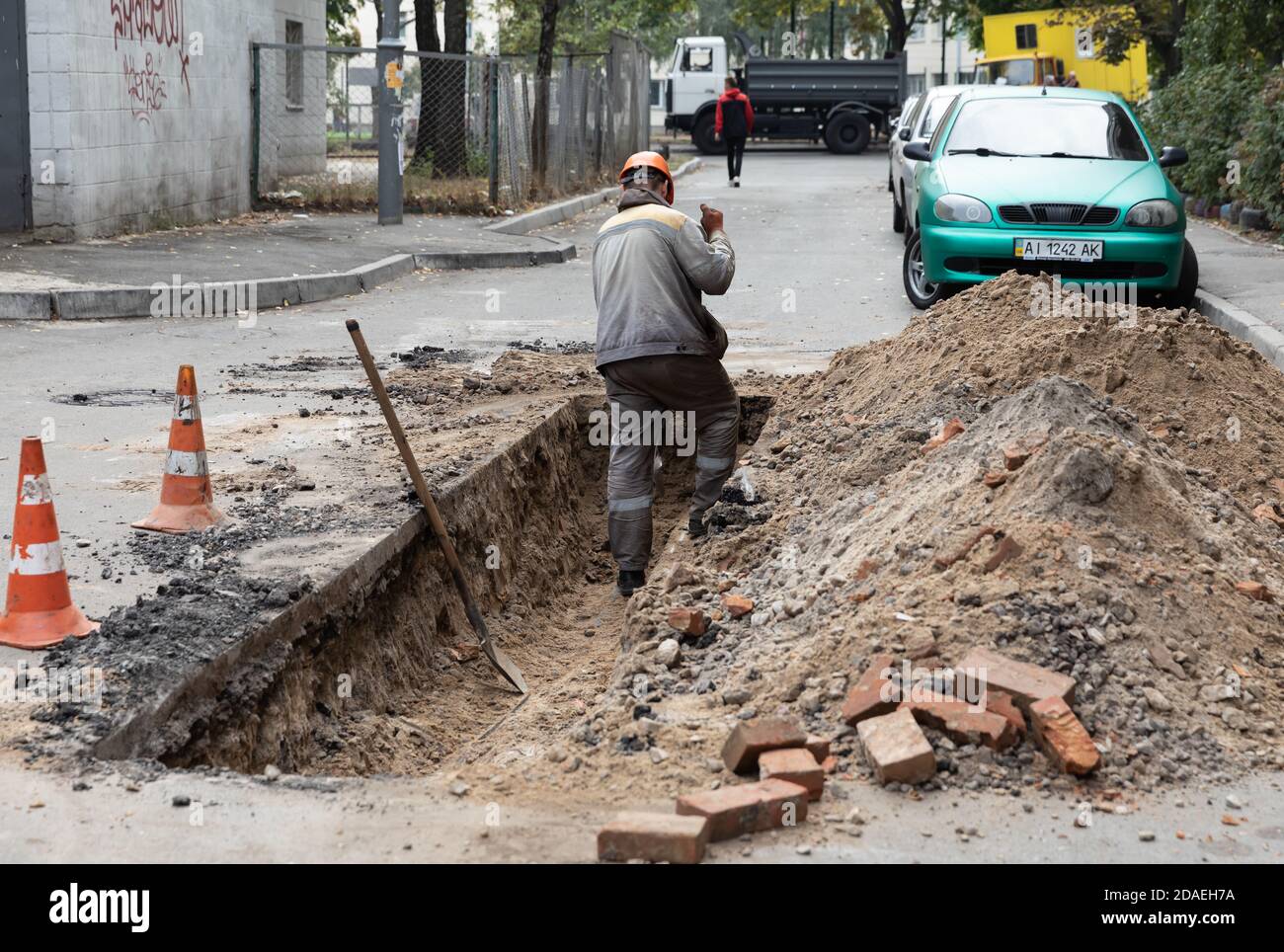 KYIV, UKRAINE - Sep 28, 2019: Worker with shovel in a trench, dig ...