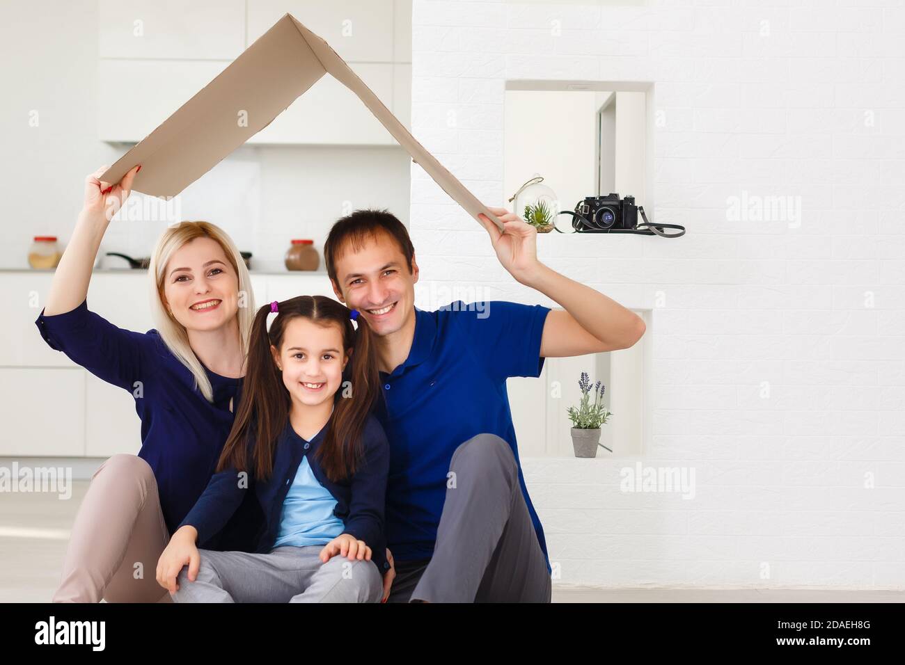 concept housing a young family. Mother father and child in new house ...