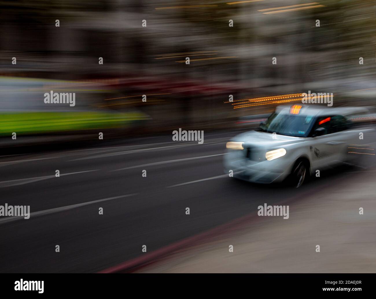 Long exposure image of car headlights at dusk on a London street, with ...