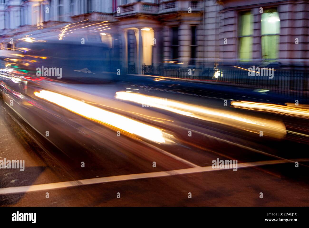 Long exposure image of car headlights at dusk on a London street, with ...
