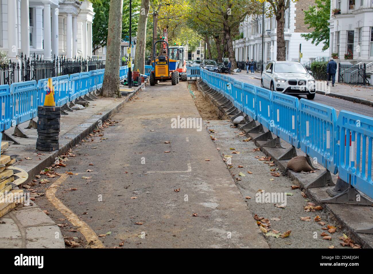 Mechanical digger resurfacing a road in West London Stock Photo - Alamy