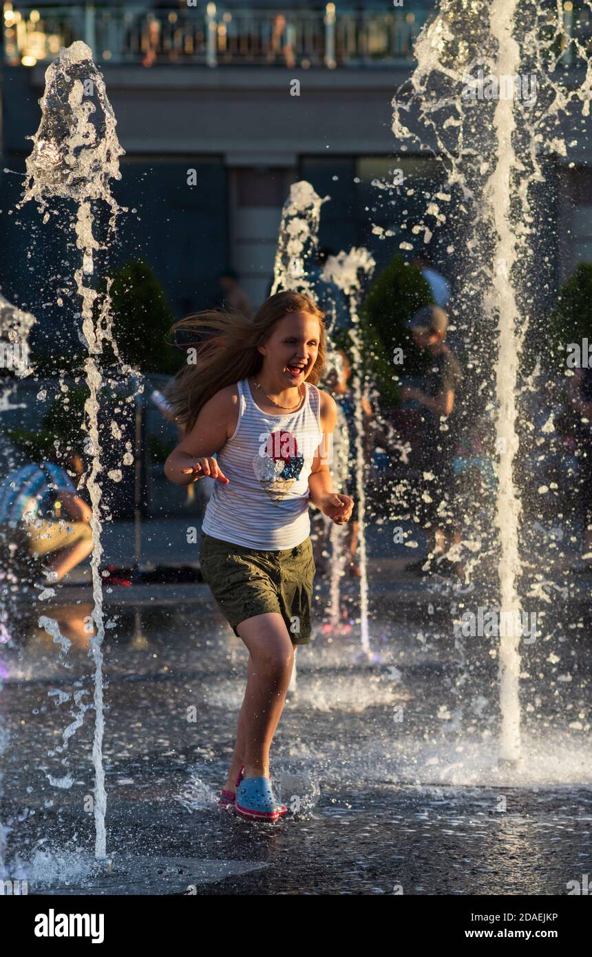 KIEV, UKRAINE - Jun 05, 2018: Cheerful and happy girl playing in a ...