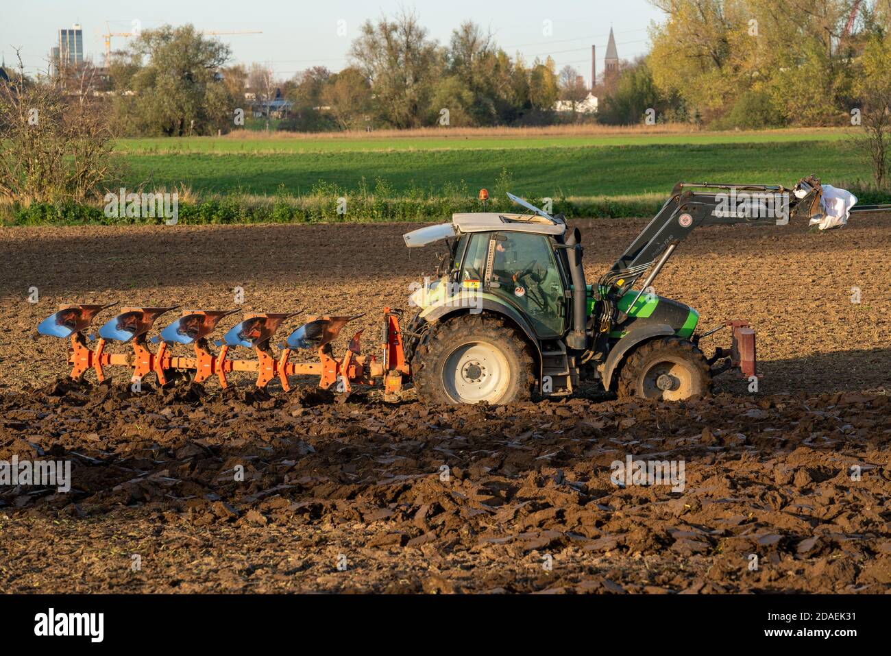 Farmer ploughing a field, tractor with plough, near Neuss, NRW, Germany ...