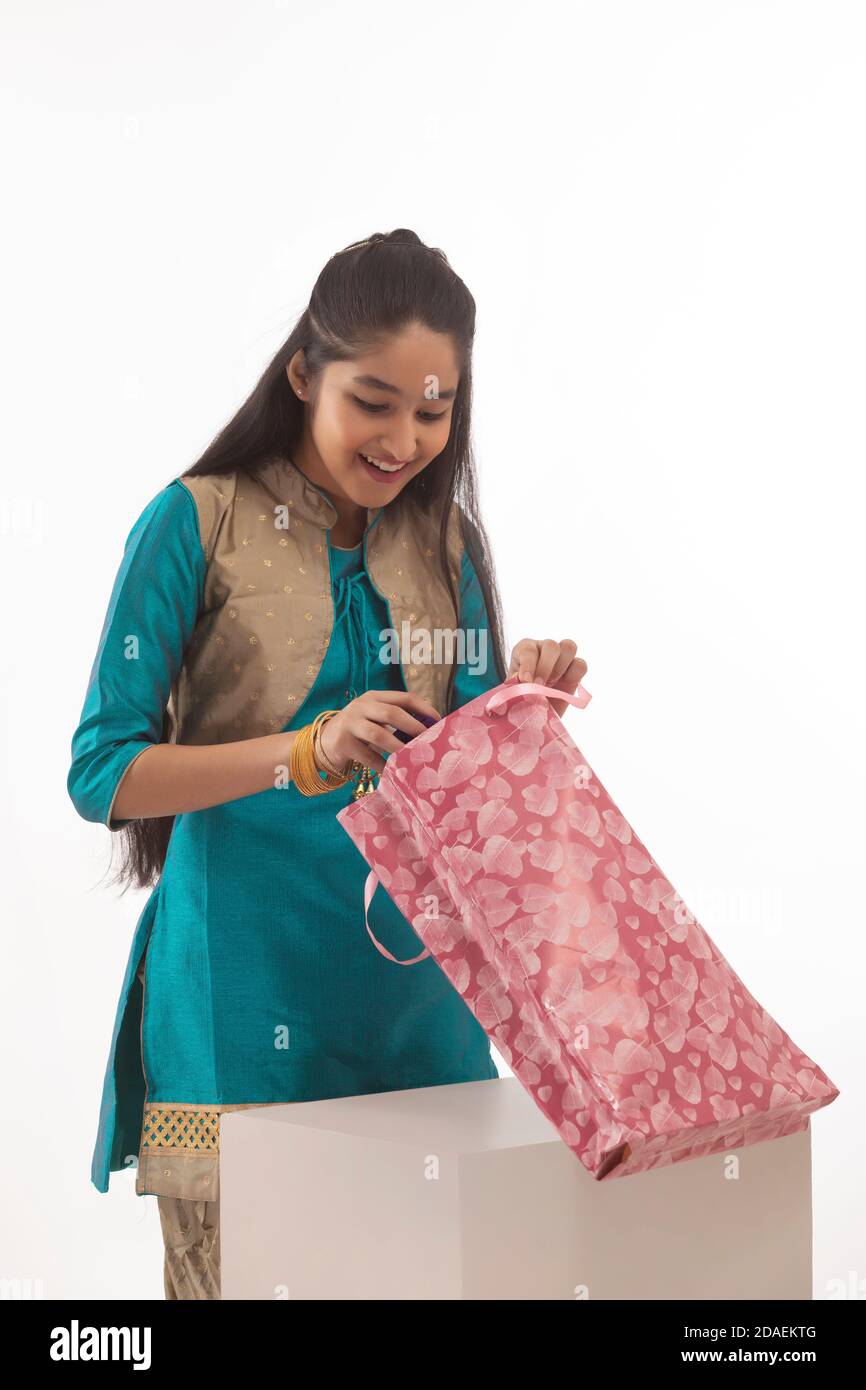 young girl opening her gift and taking out her present Stock Photo - Alamy