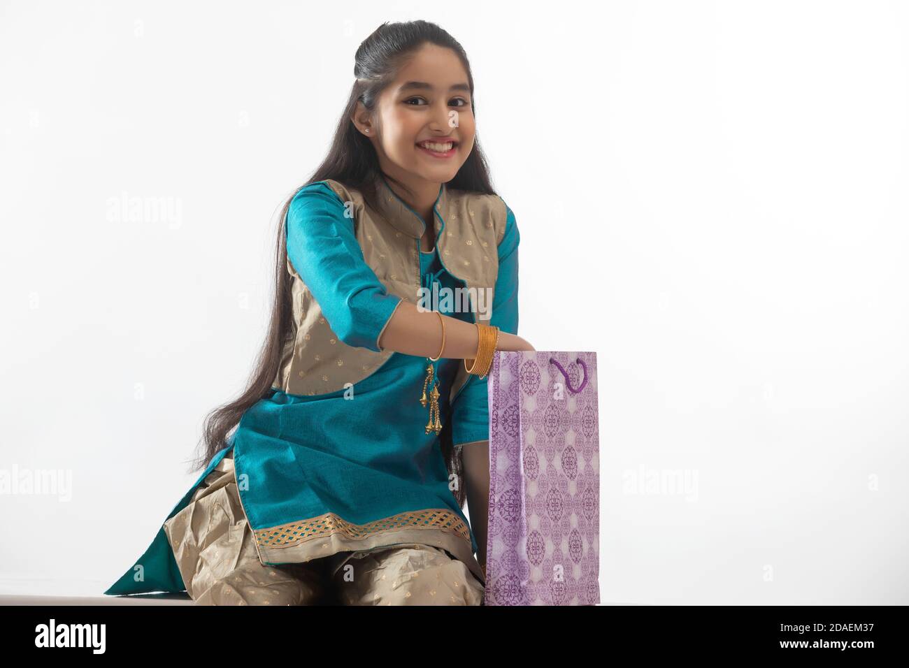 Young girl putting her hand in a gift packet Stock Photo - Alamy