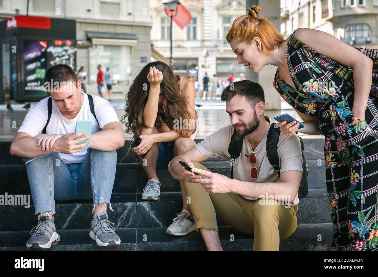 Group of friends using smartphones together. Young people addiction to ...