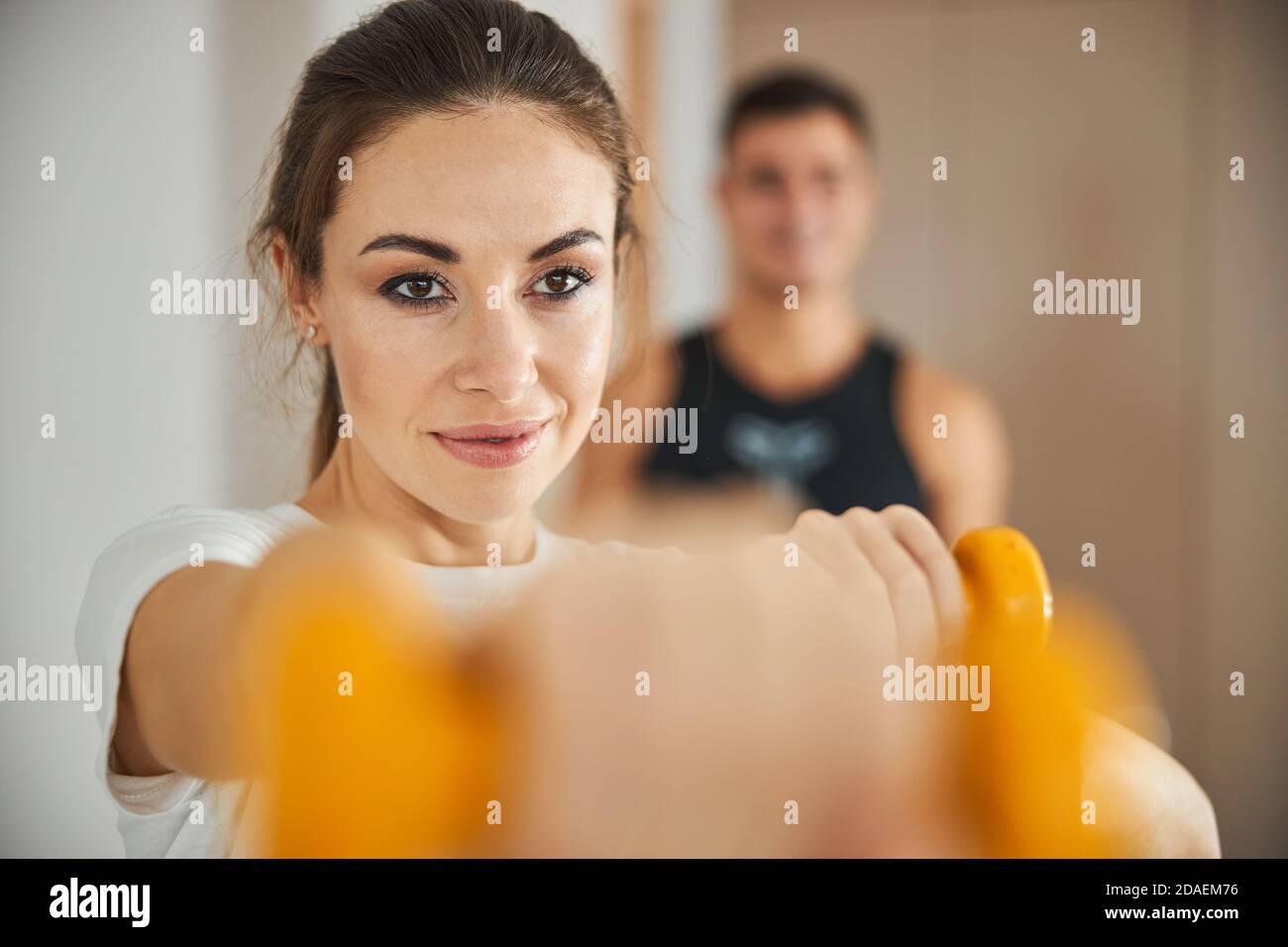 Attractive young lady doing a home workout with her man Stock Photo - Alamy
