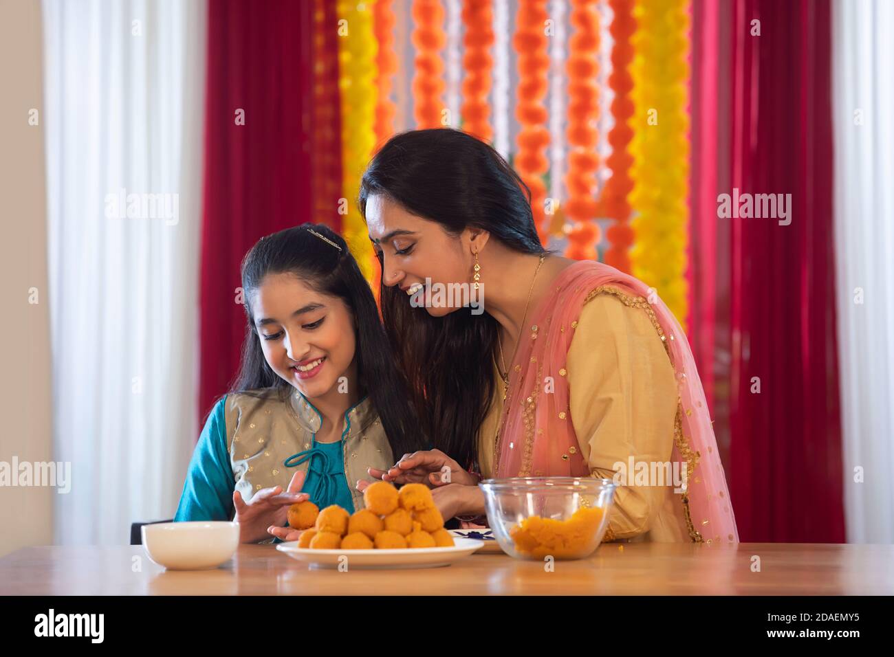 Mother and daughter making sweets together Stock Photo - Alamy