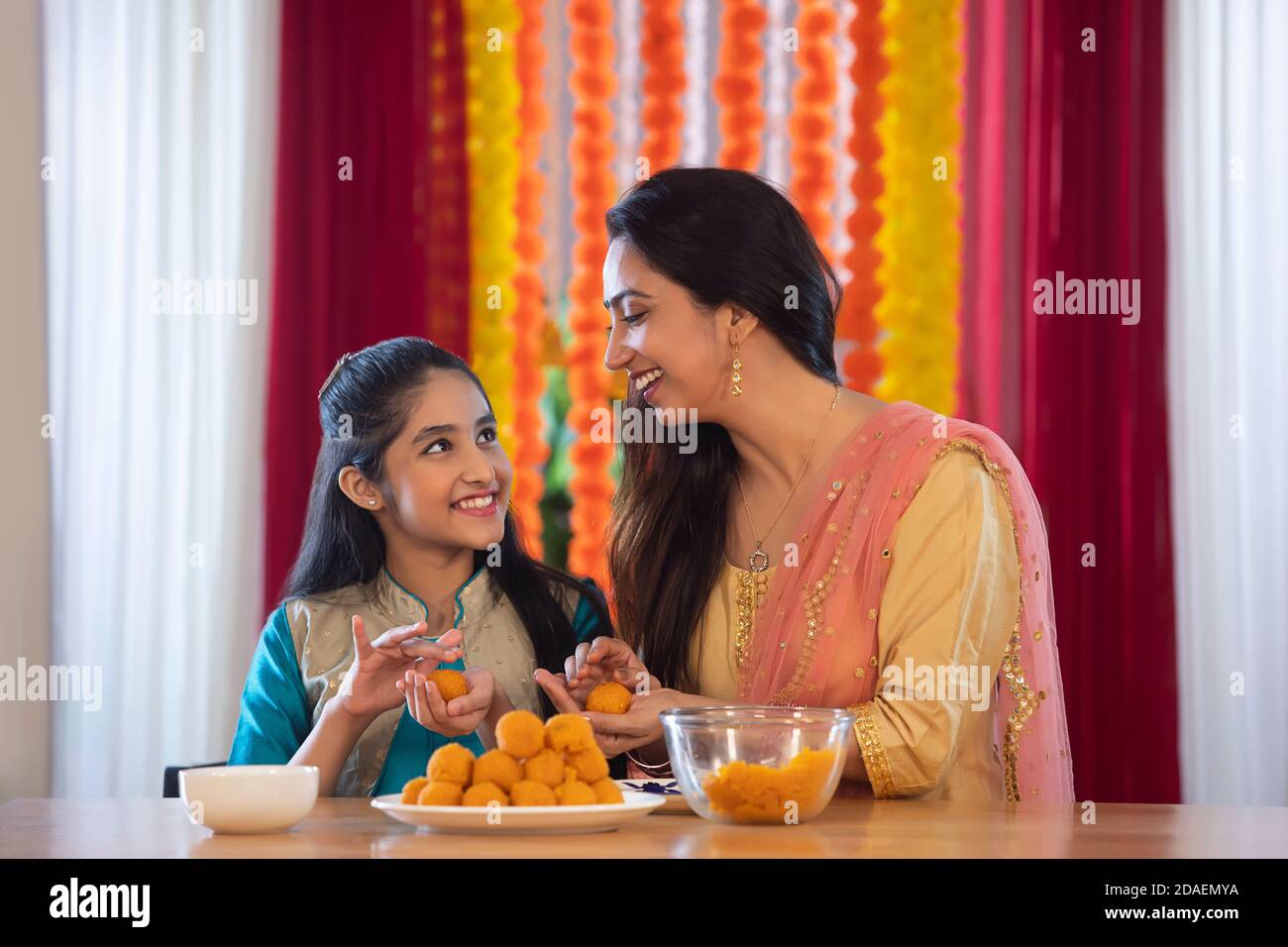 Mother and daughter making sweets together Stock Photo - Alamy