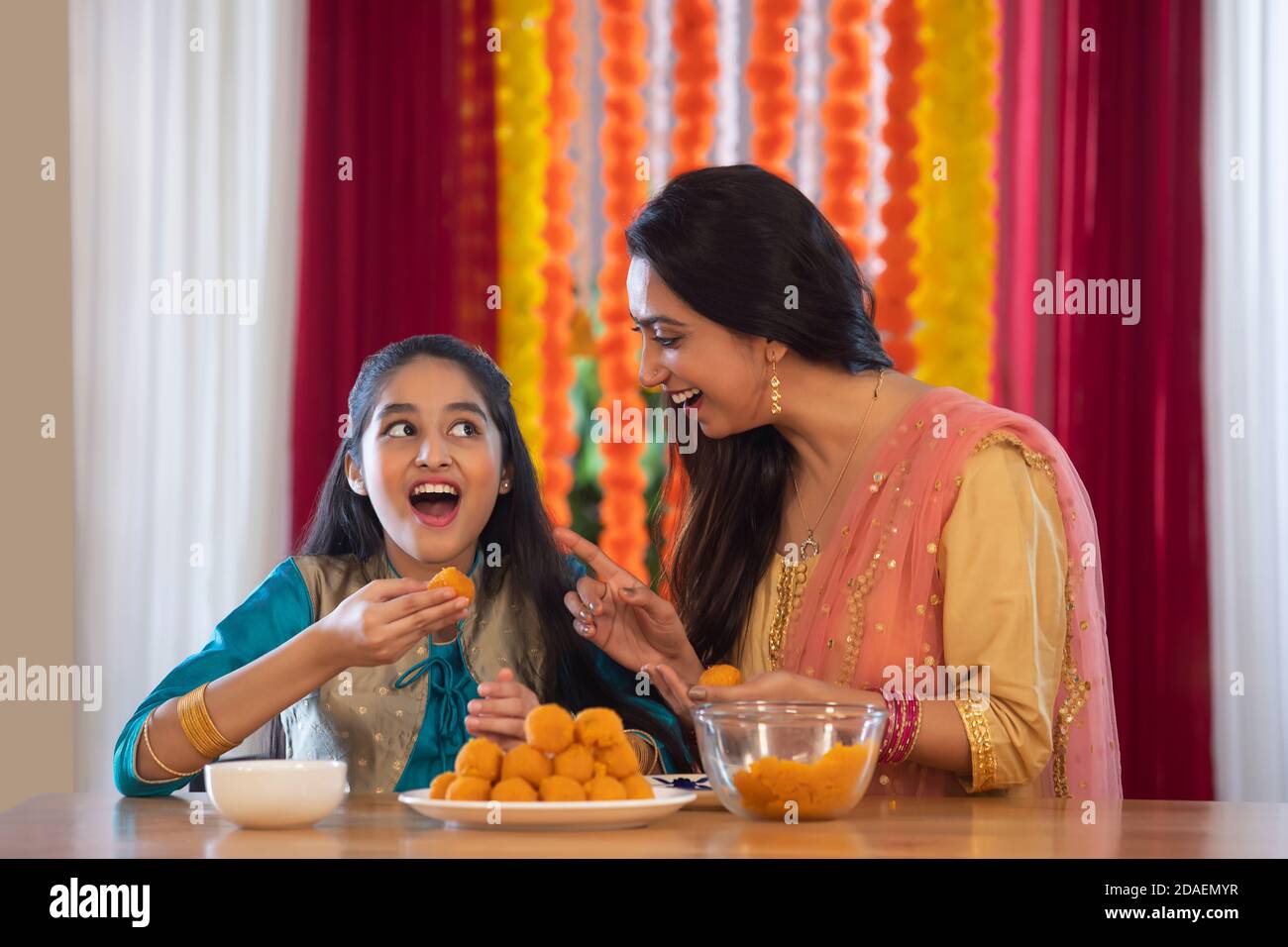 Indian child eating with mother hi-res stock photography and images - Alamy