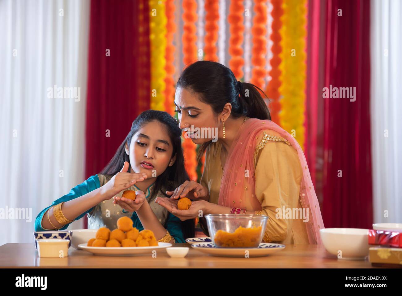 Mother and daughter making sweets together Stock Photo - Alamy