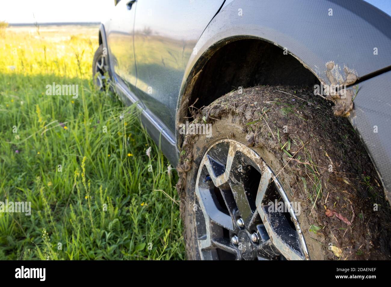 Close up of dirty off road car wheels with dirty tires covered with ...