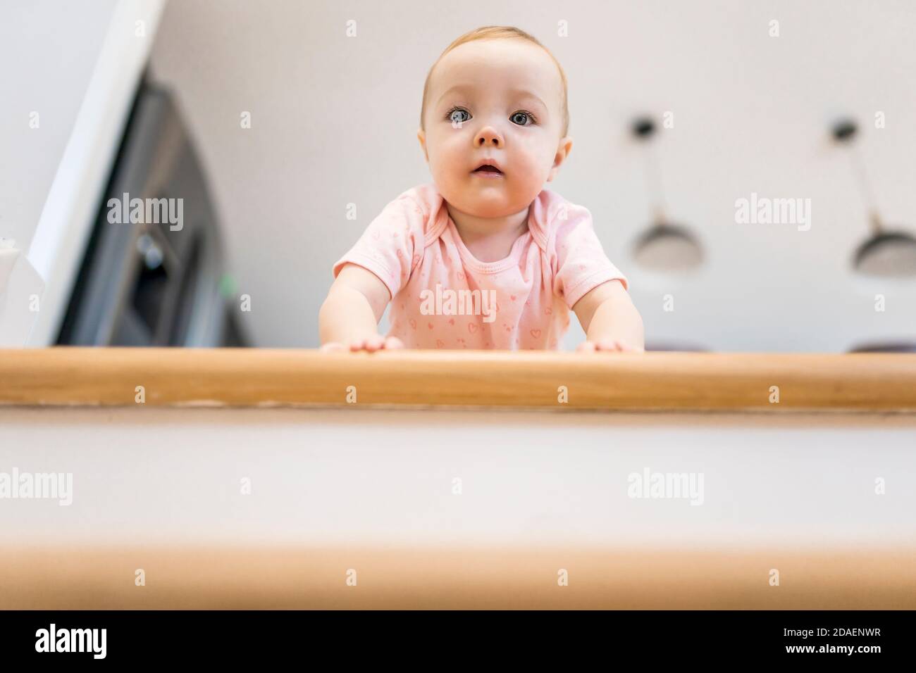 Lonely baby girl in danger close to the stair Stock Photo - Alamy