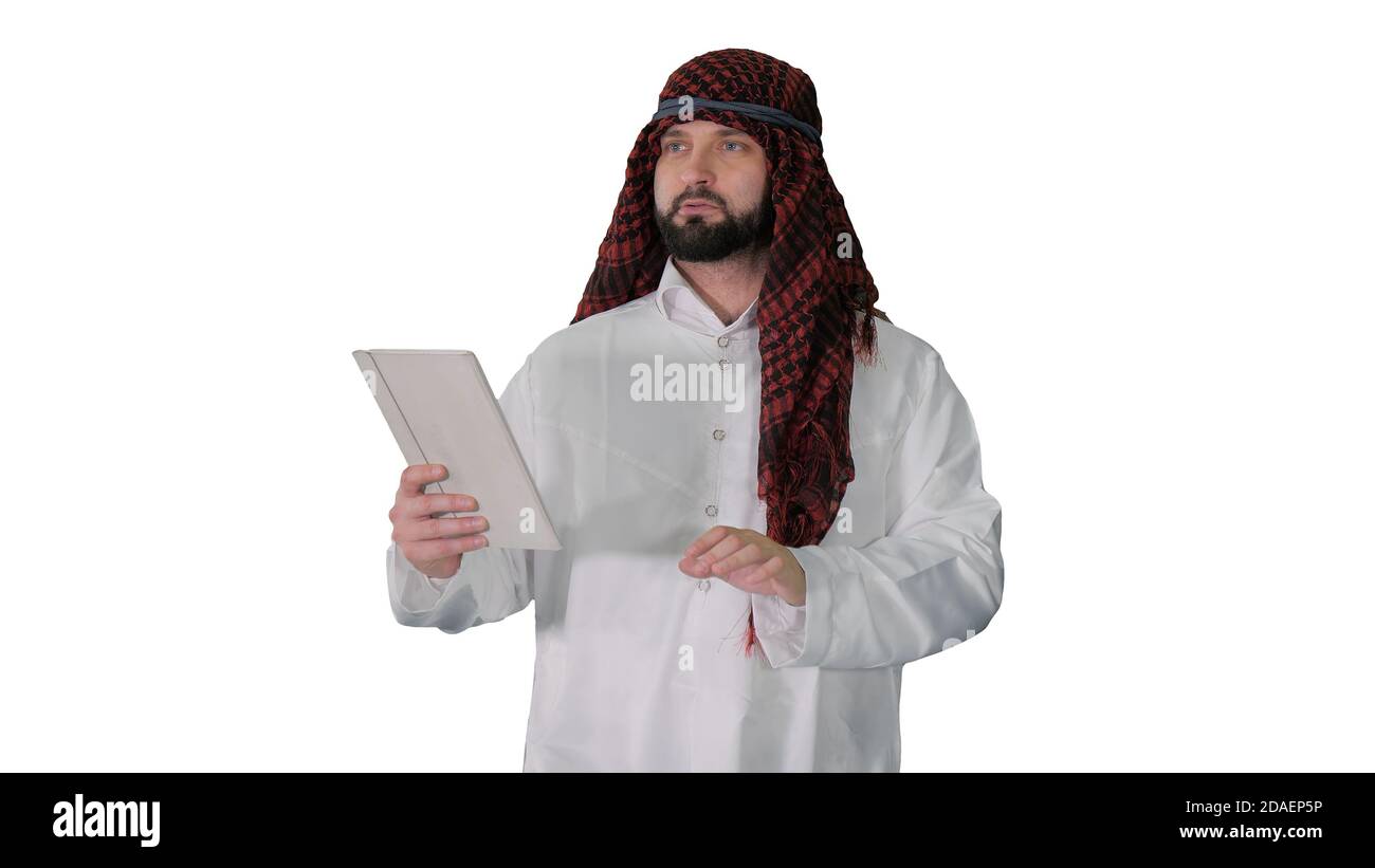 Sheikh using digital tablet and walking on white background Stock Photo ...