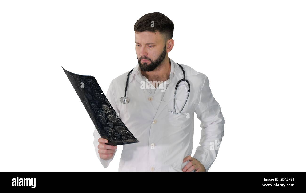 Doctor from middle east walking and looking at ct scan on white Stock ...