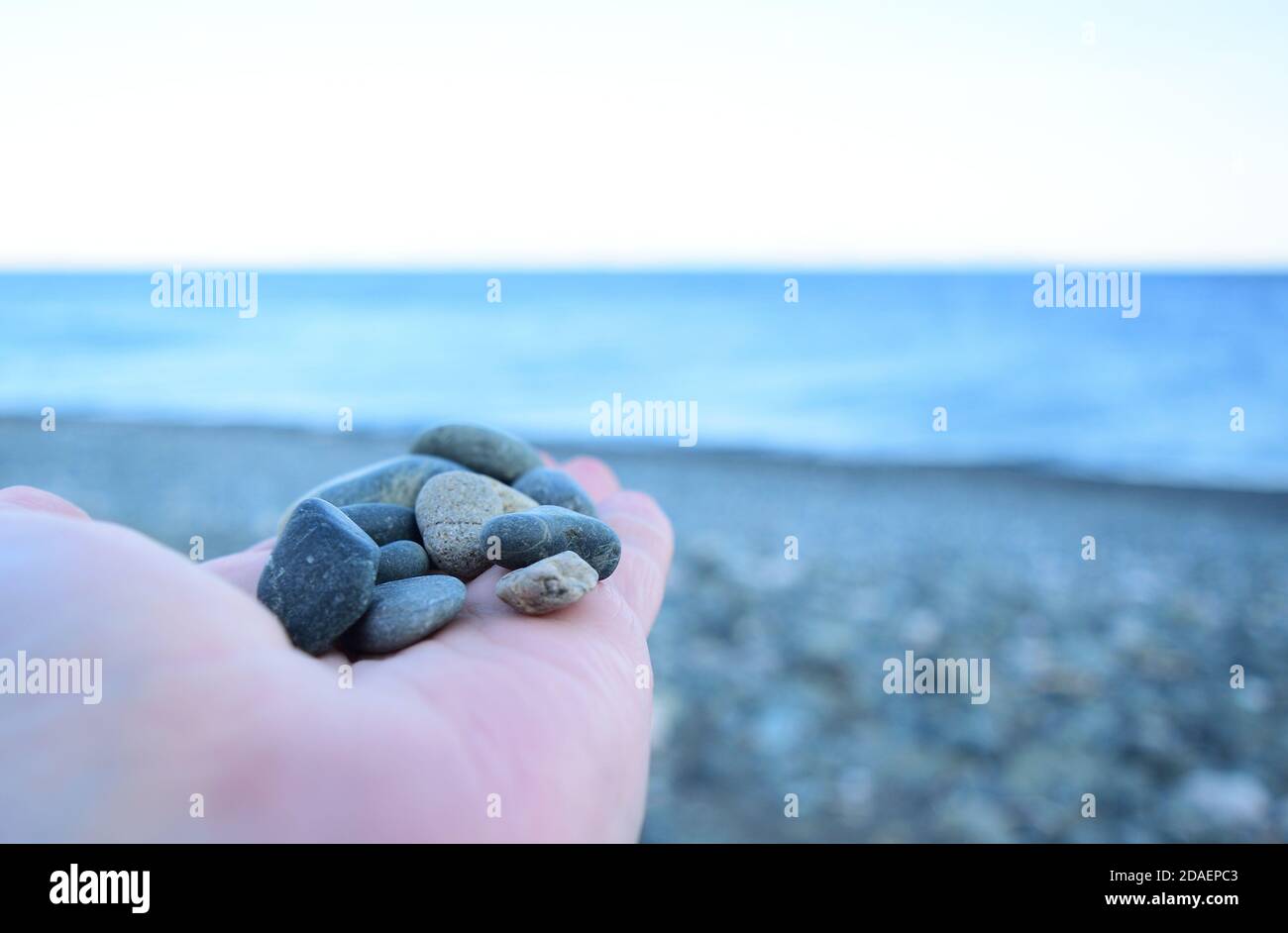 My offer for today: the calm of pebbles. Hand holding stones. Kipos ...