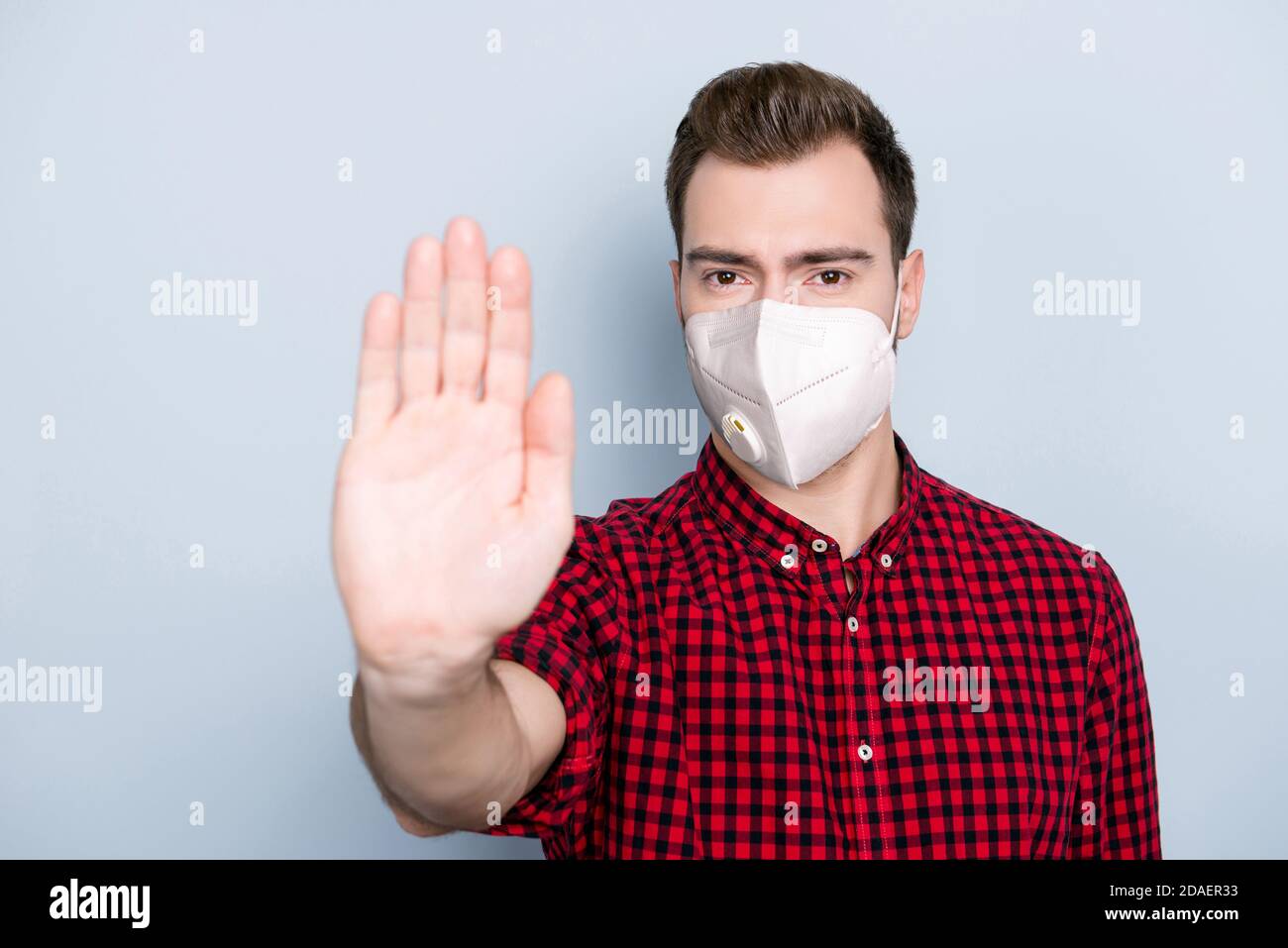 Photo portrait of man with extended arm showing palm wearing white ...
