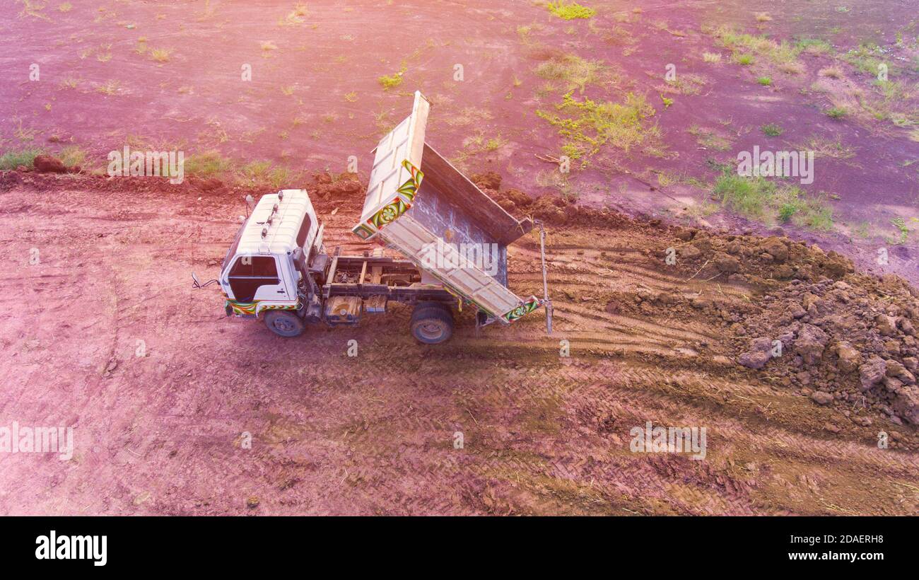 Dump truck unloads soil on the construction site Stock Photo - Alamy