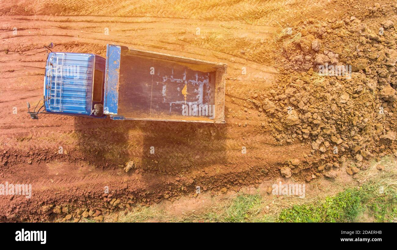 Dump truck unloads soil on the construction site Stock Photo - Alamy