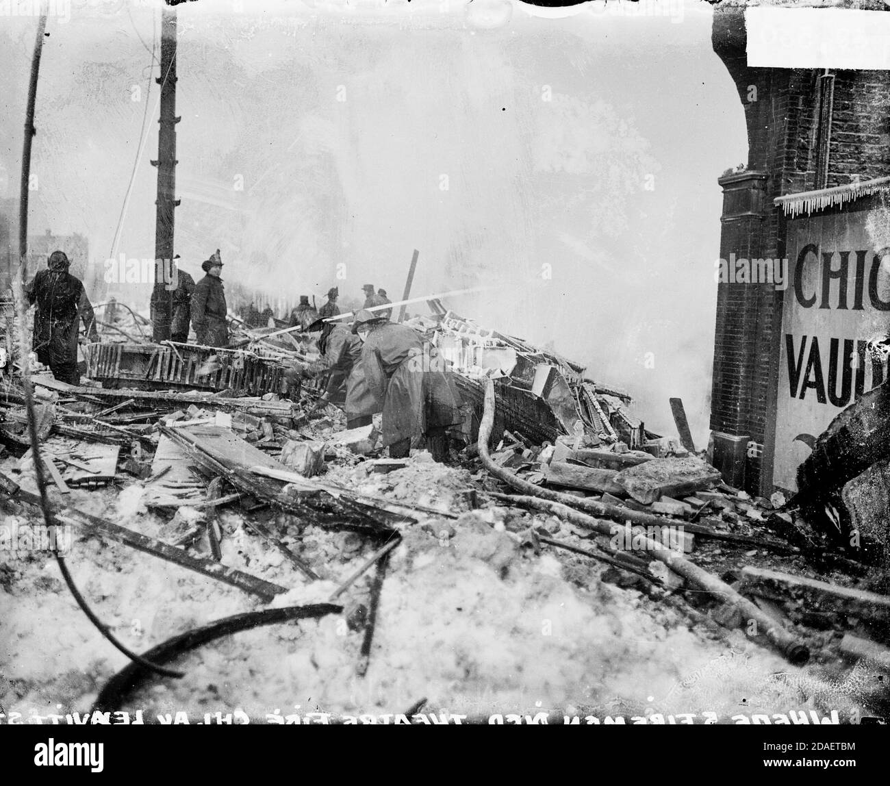 Firemen standing in the rubble after a fire at a theater on West ...