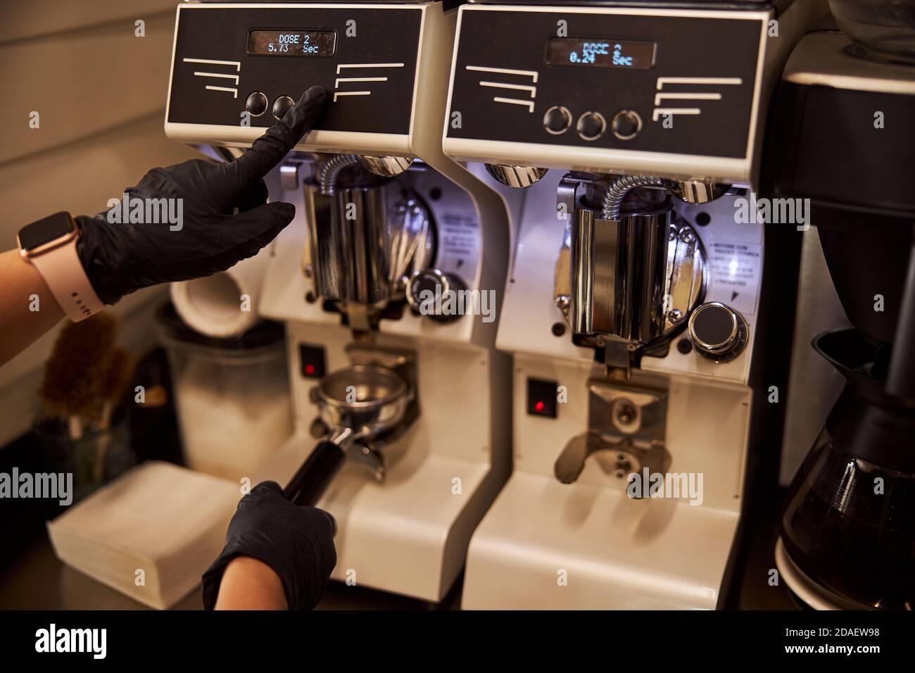 Experienced barista using modern coffee-grinder at work Stock Photo - Alamy