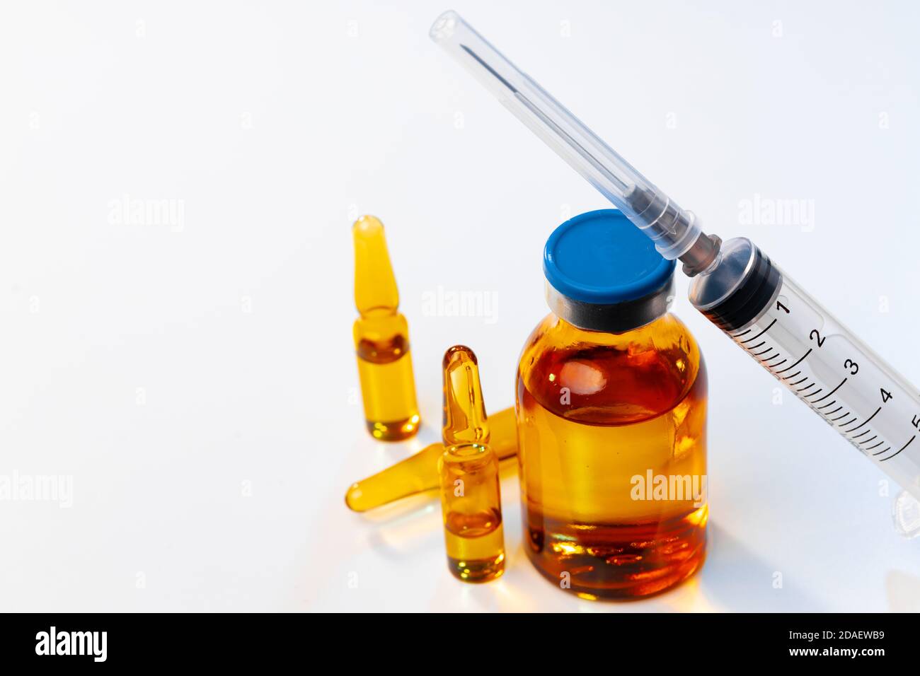 Medical vial with medication and syringe close up Stock Photo - Alamy