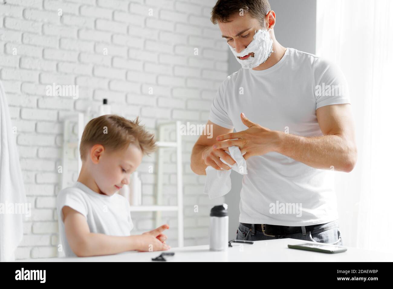 Father teaches his little son how to shave face Stock Photo - Alamy