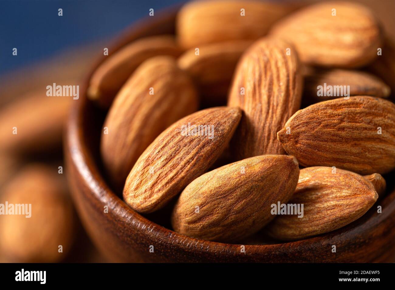 Extreme close-up of fresh raw almonds in a brown wooden bowl Stock ...
