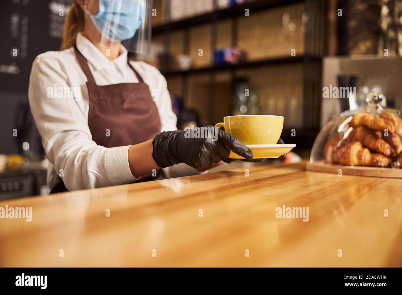 Wooden surface of the bar counter and barista working at it Stock Photo ...